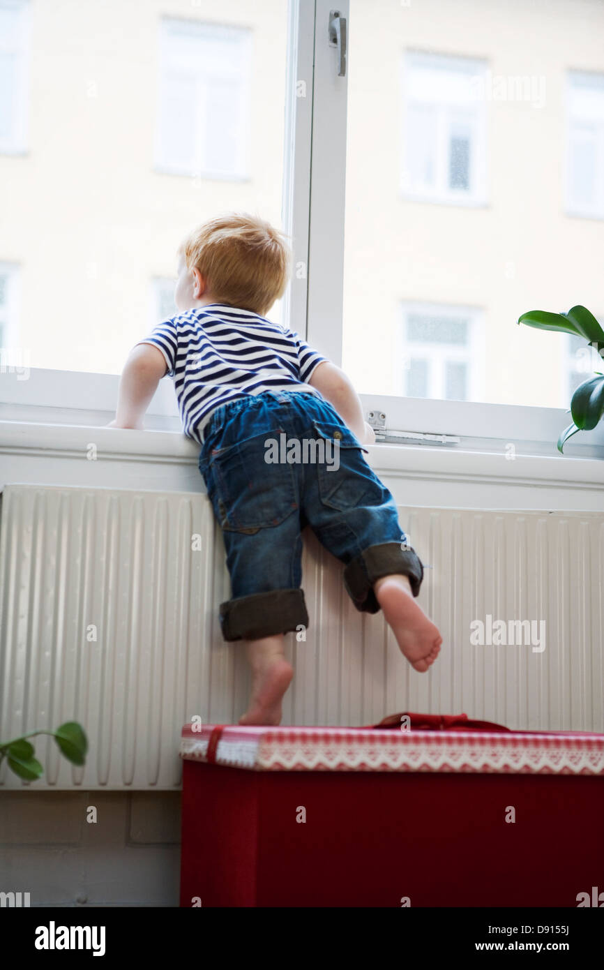 Child looking through a window, Sweden Stock Photo - Alamy