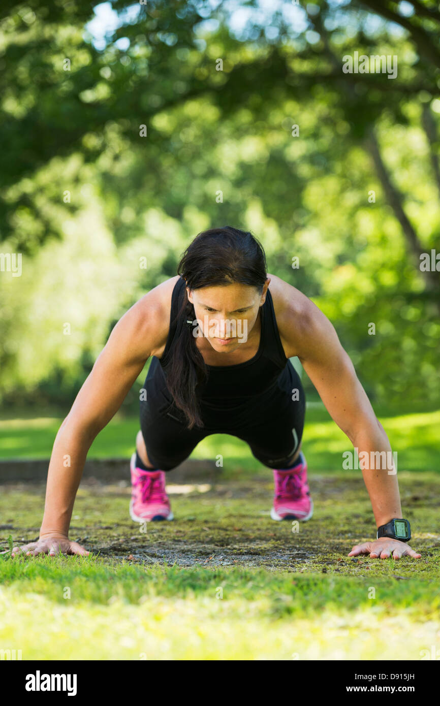 Woman doing push-ups in garden Stock Photo - Alamy