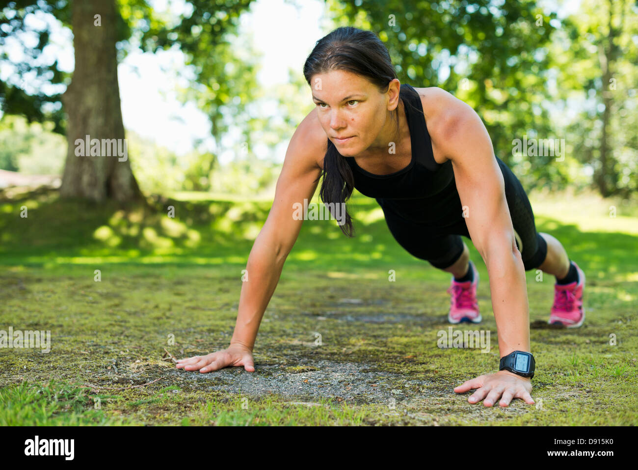 Woman doing push-ups in garden Stock Photo - Alamy