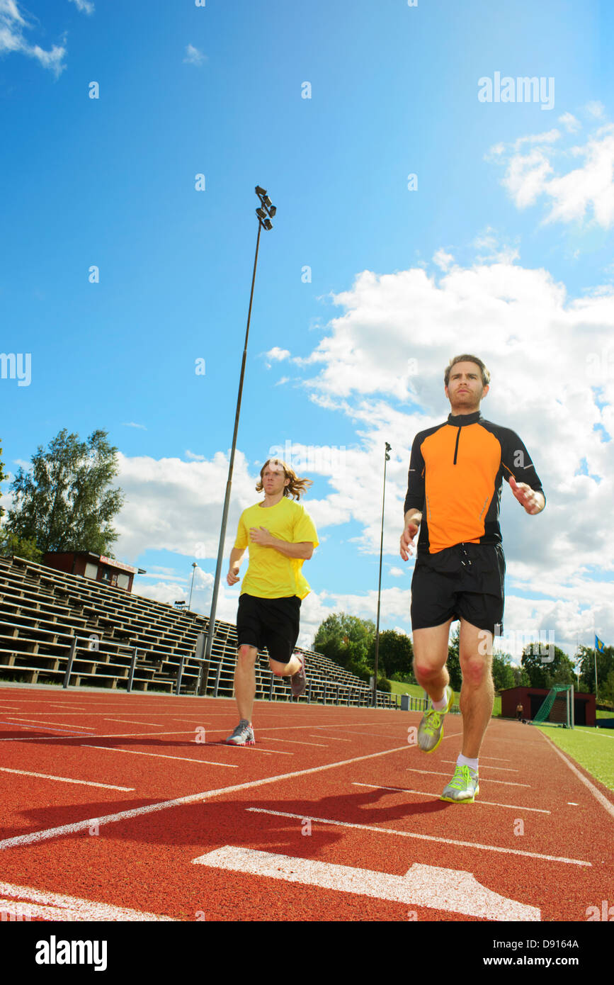 Two men running on stadium Stock Photo - Alamy