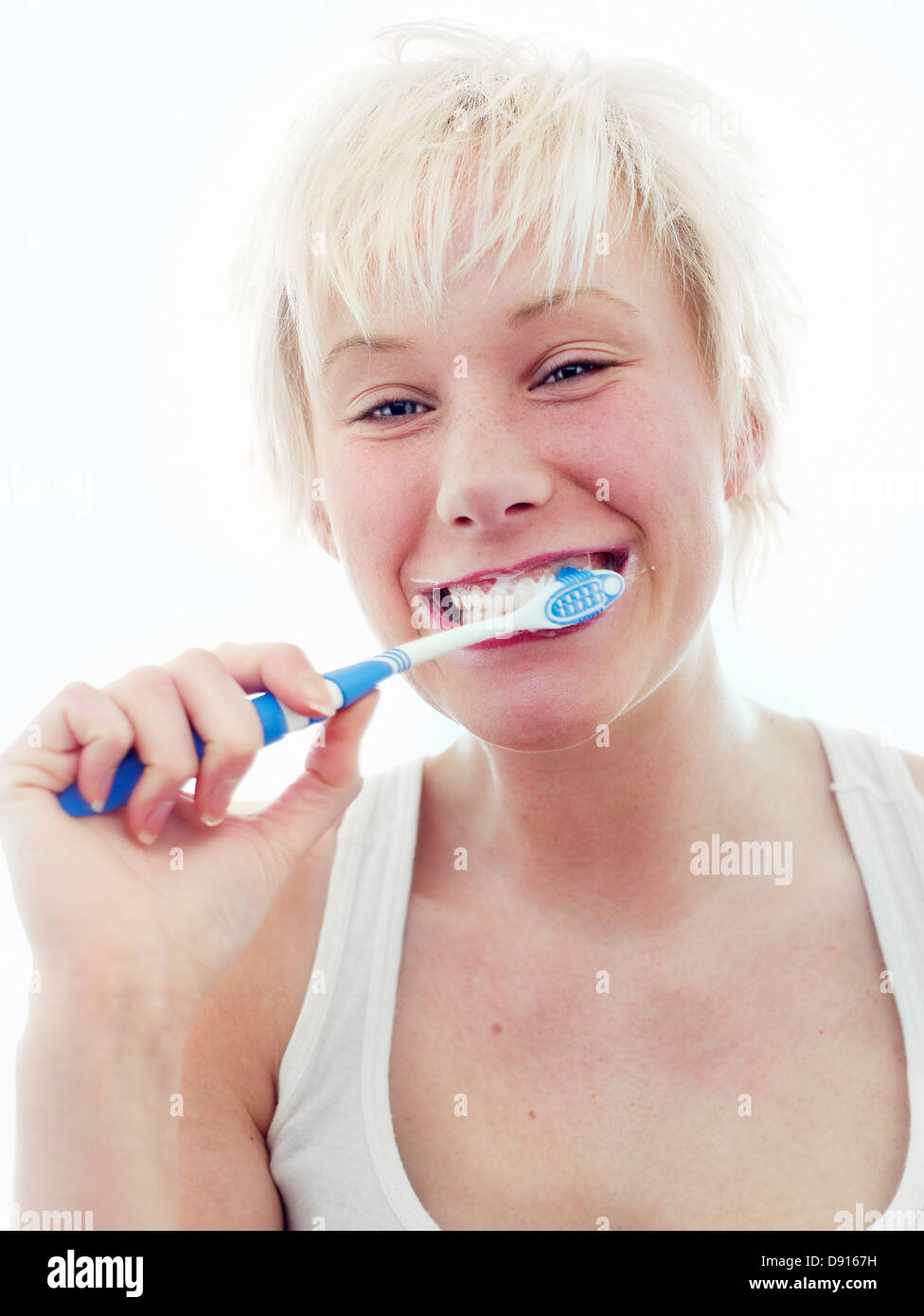 A Scandinavian teenage girl brushing her teeth Stock Photo - Alamy