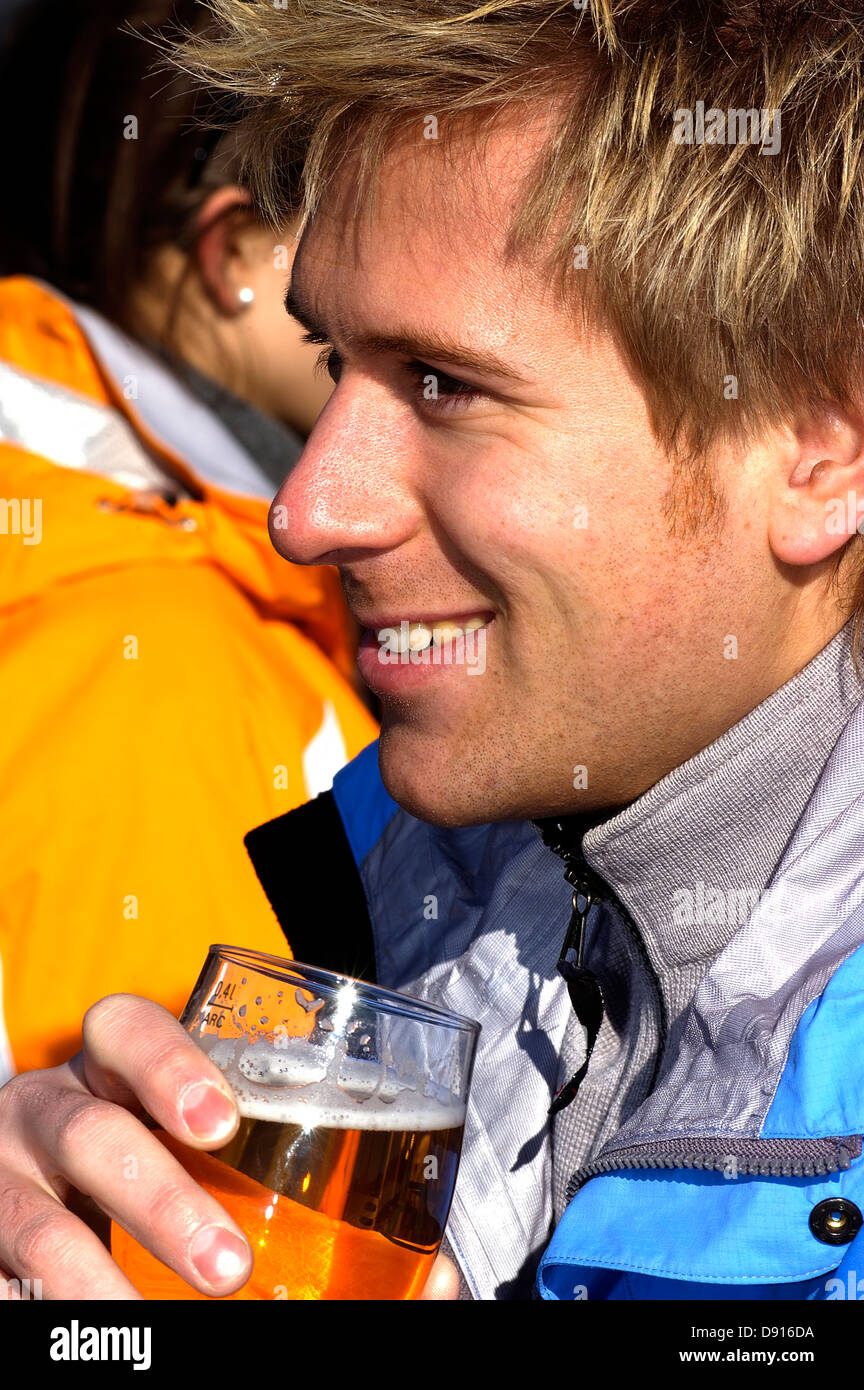 Portrait of a male skier drinking beer Stock Photo - Alamy