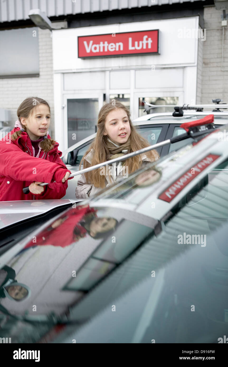 Girls washing car window Stock Photo - Alamy
