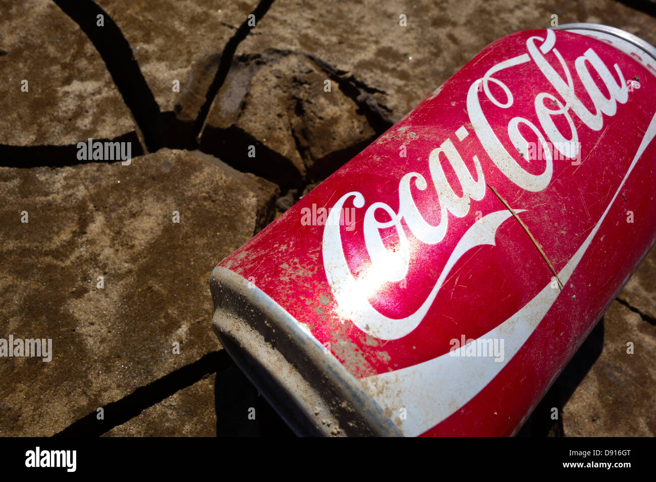 Cracked dry earth with coca cola can Stock Photo - Alamy