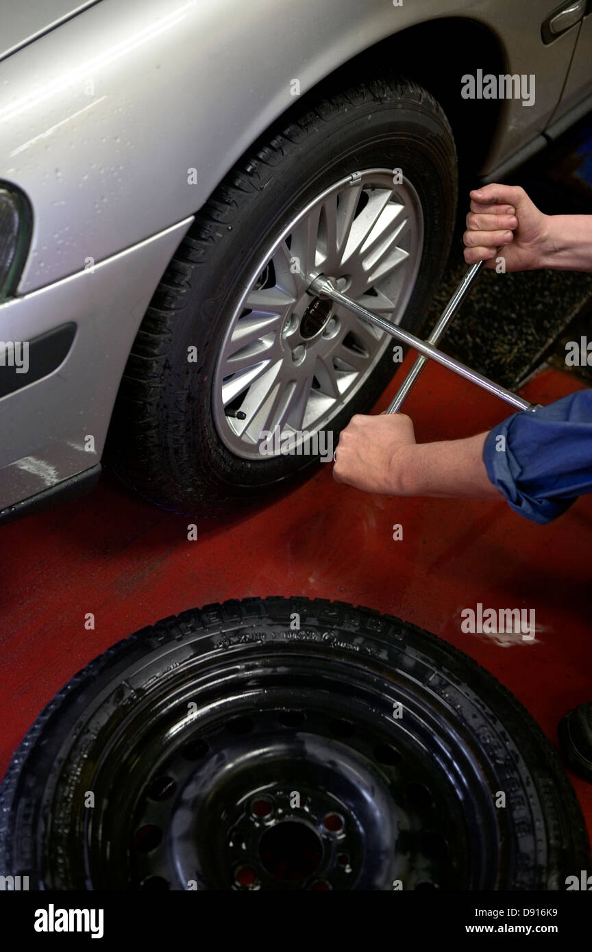 Man changing tire Stock Photo - Alamy