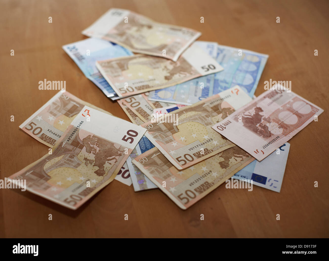 Euro bills on a table Stock Photo - Alamy