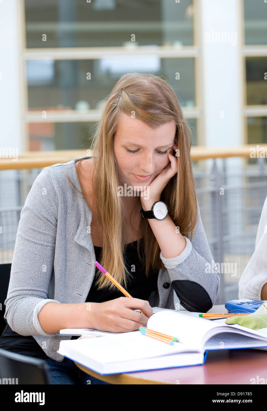 Young student writing Stock Photo - Alamy