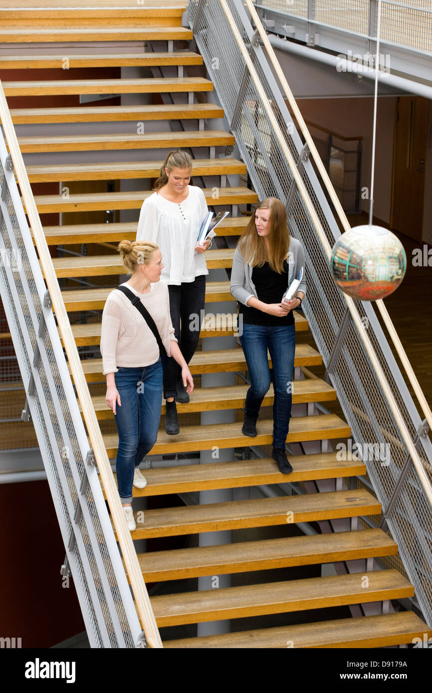 Three university student on stairs Stock Photo - Alamy