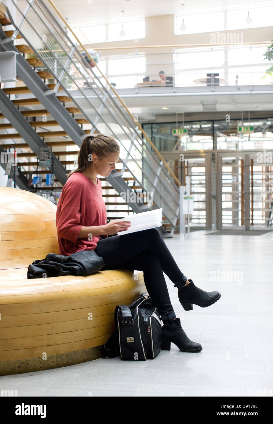 Student on university corridor Stock Photo - Alamy