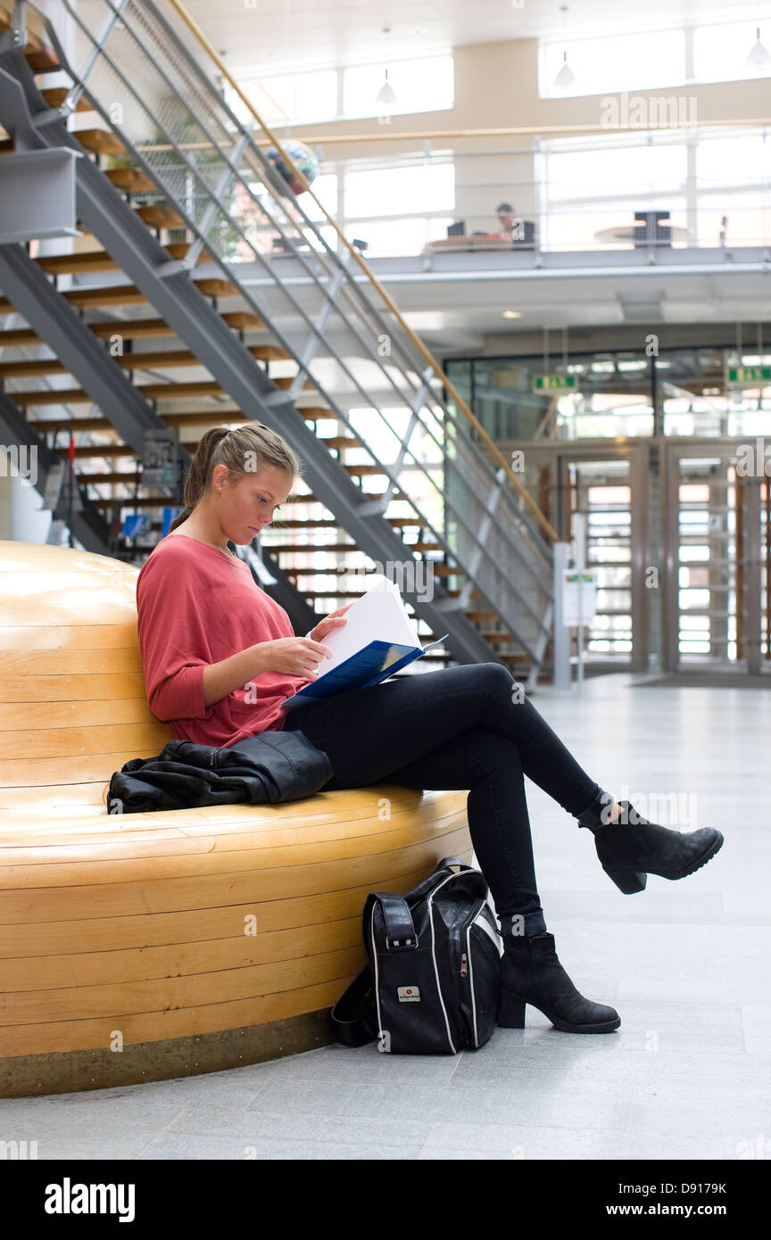 Student on university corridor Stock Photo - Alamy