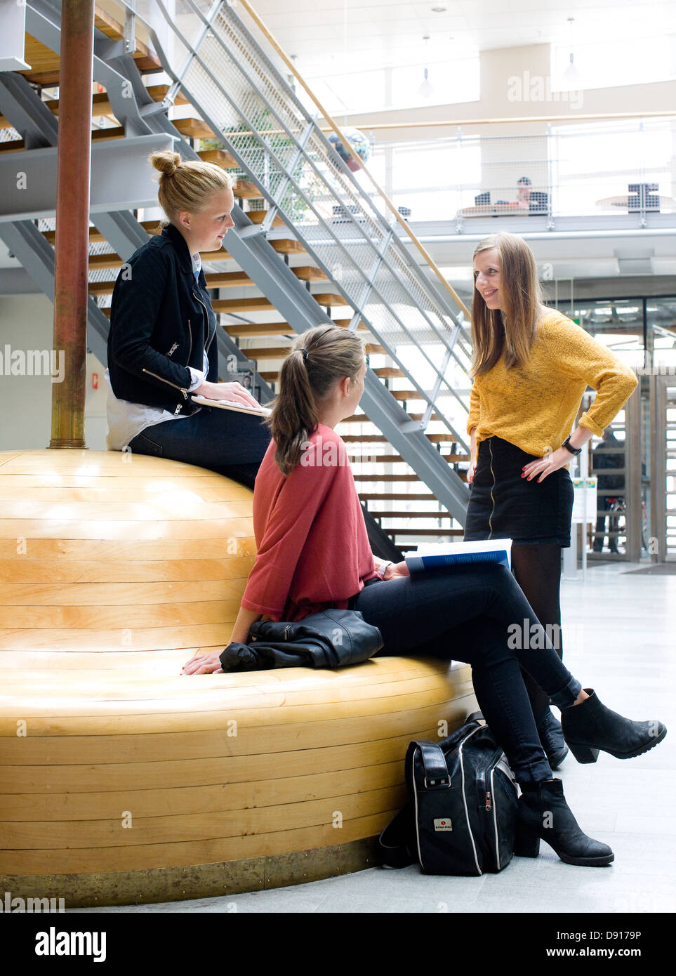 Students on university corridor Stock Photo - Alamy