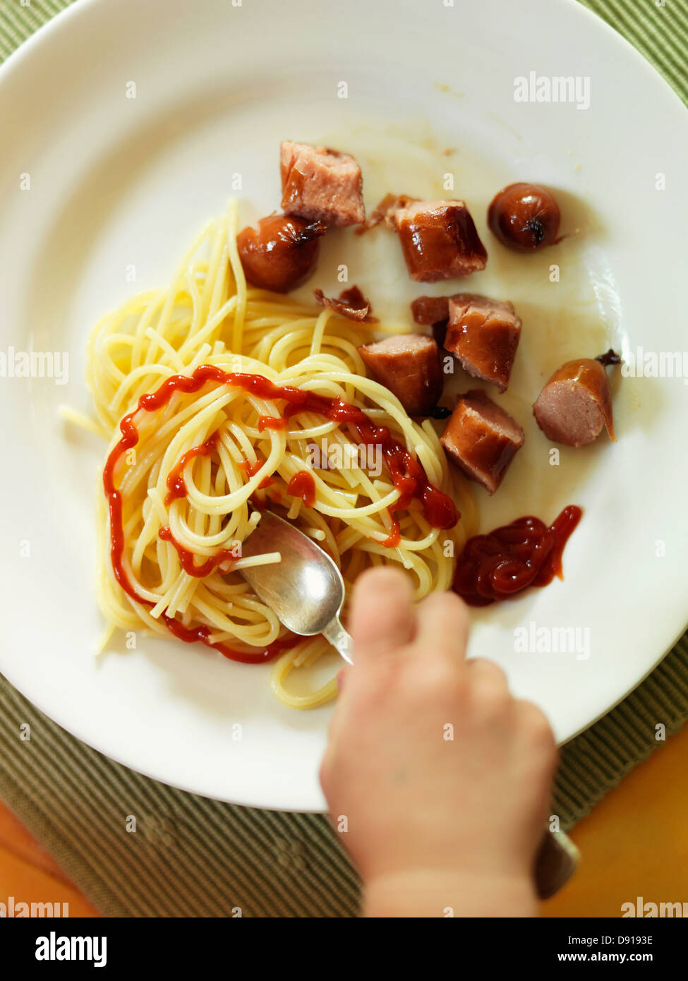 The hand of a child eating spaghetti, close-up Stock Photo - Alamy