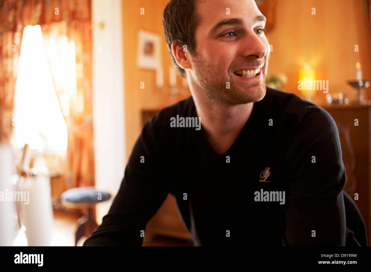 A laughing man in a cafe Stock Photo - Alamy