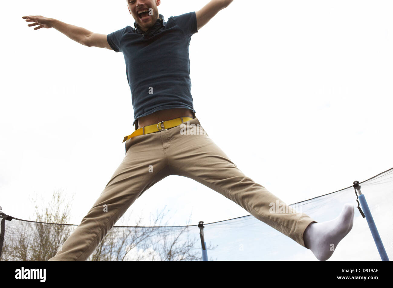 The legs of a man jumping on a trampoline Stock Photo - Alamy