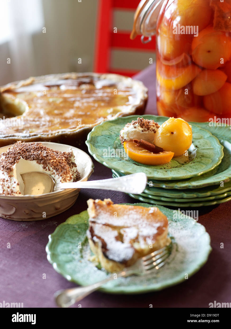 Preserved plums served with whipped cream Stock Photo - Alamy