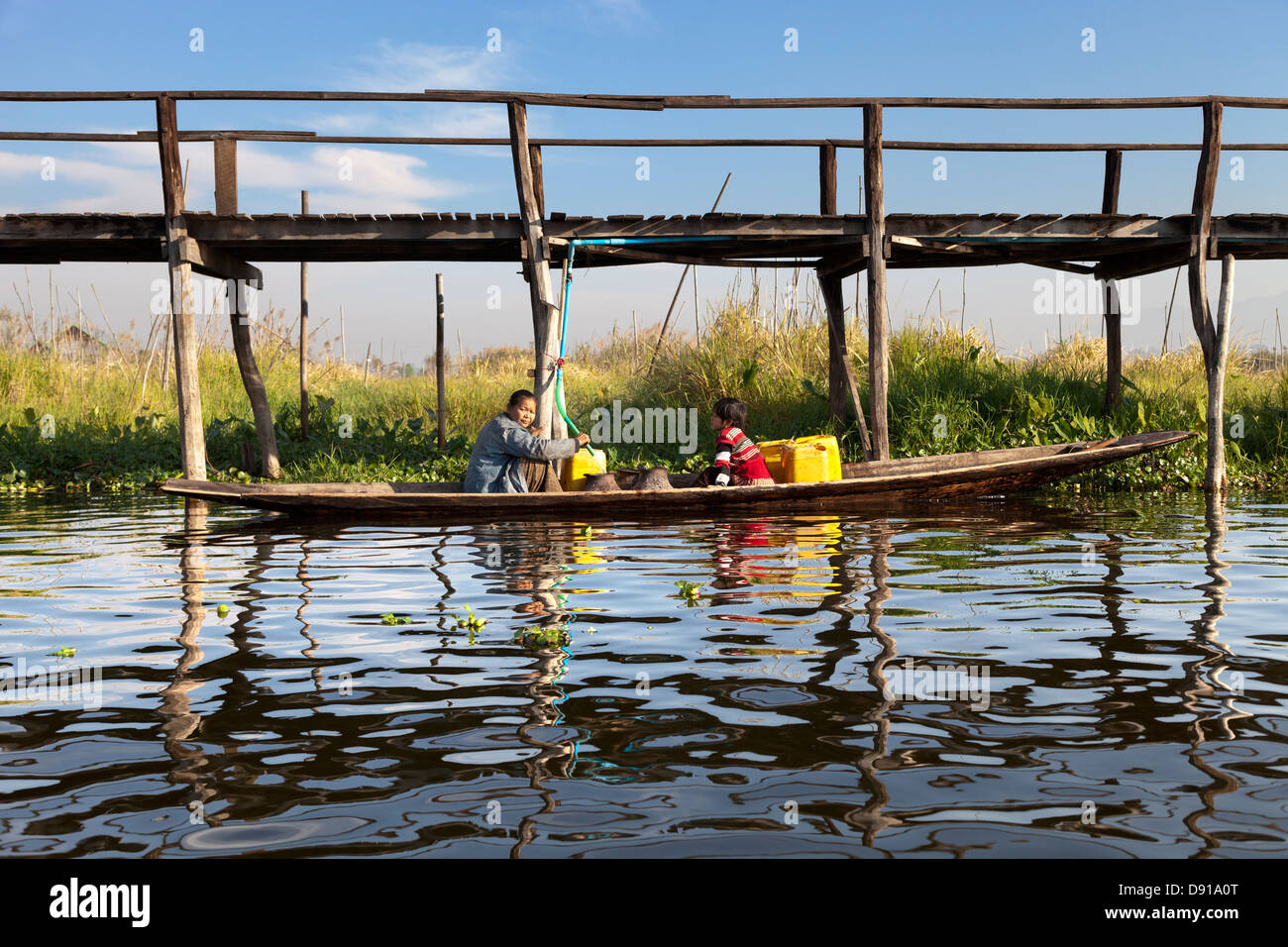 Small boat taking on fresh water by a jetty, Inle Lake Myanmar 2 Stock ...