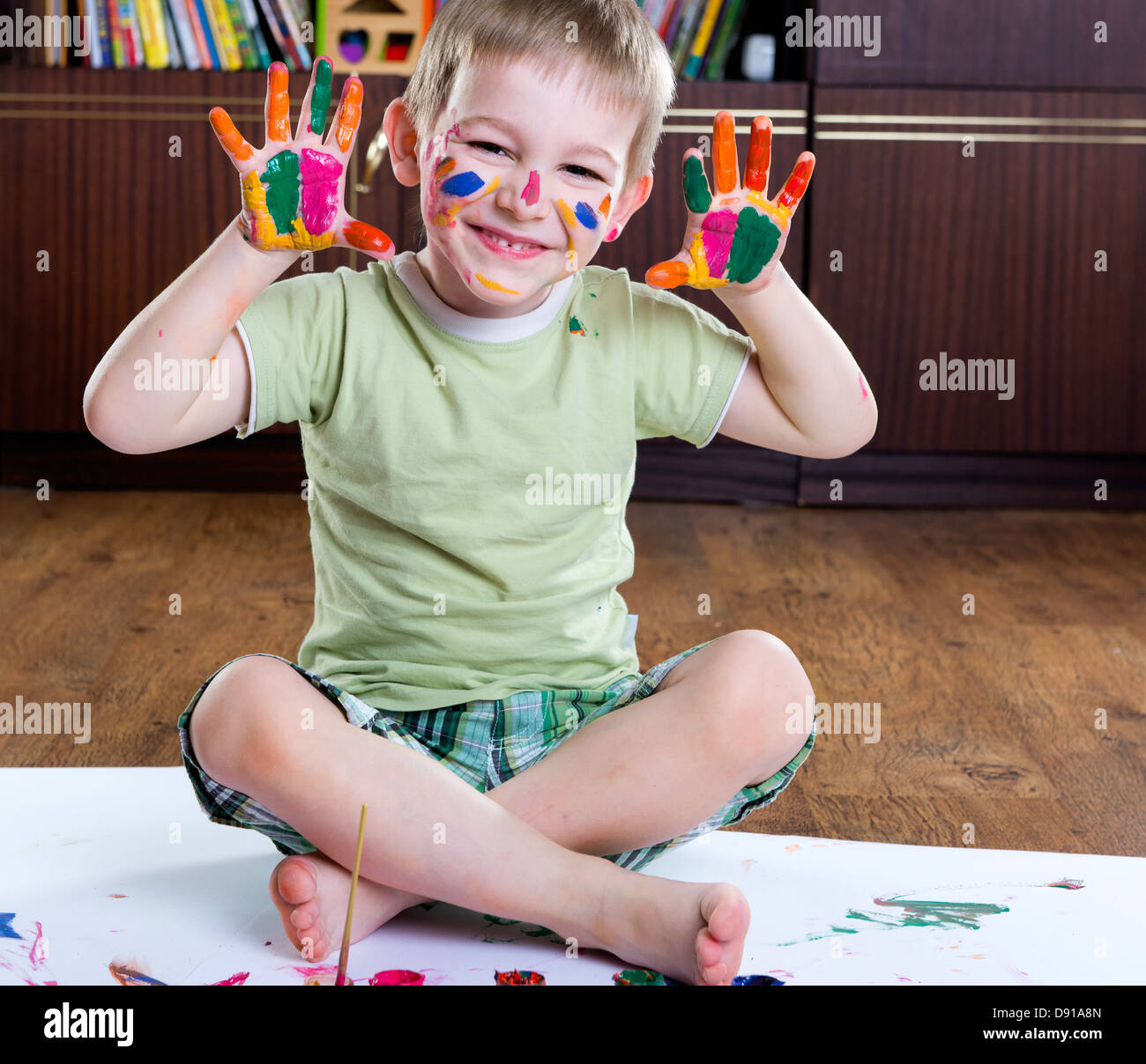 Cute happy boy painting with colorful paints Stock Photo - Alamy