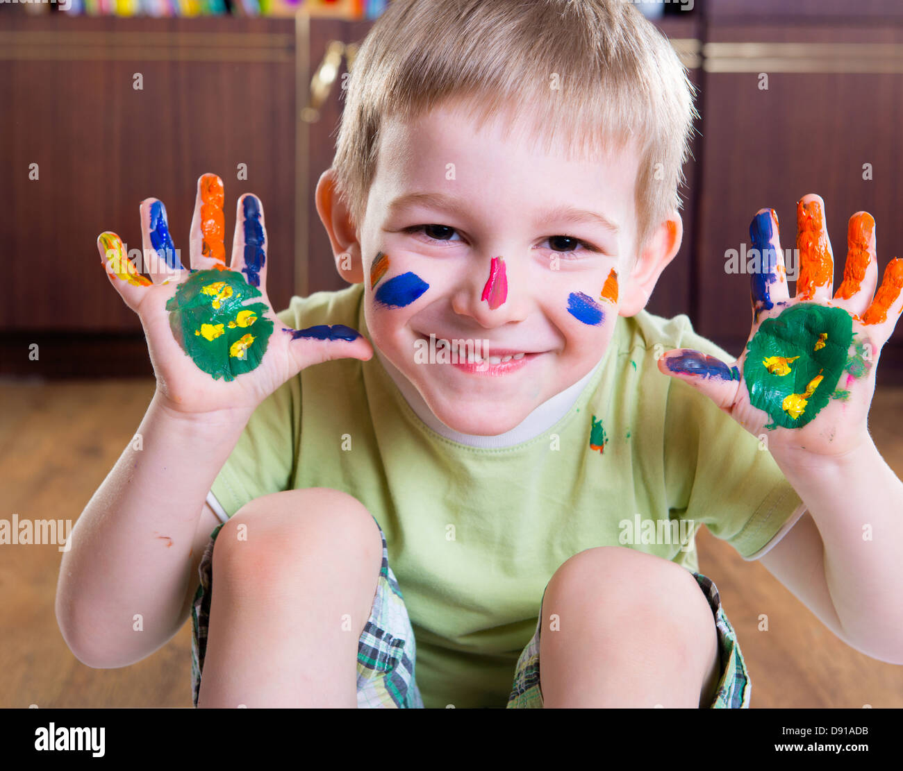 Portrait of cute happy boy with colorful painted hands Stock Photo - Alamy
