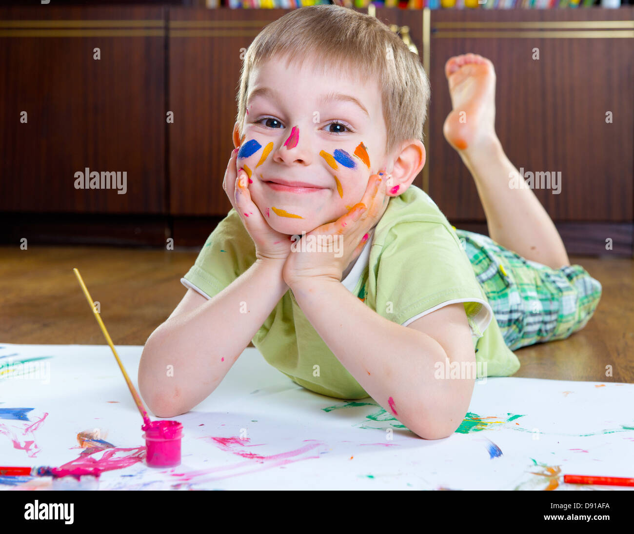 Excited little boy painting with colorful paints Stock Photo - Alamy