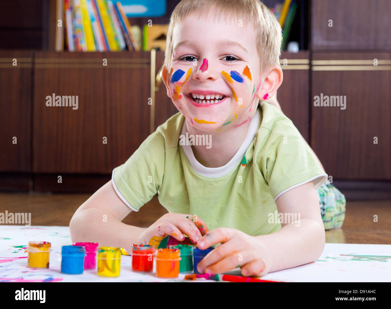 Excited little boy painting with colorful paints Stock Photo - Alamy
