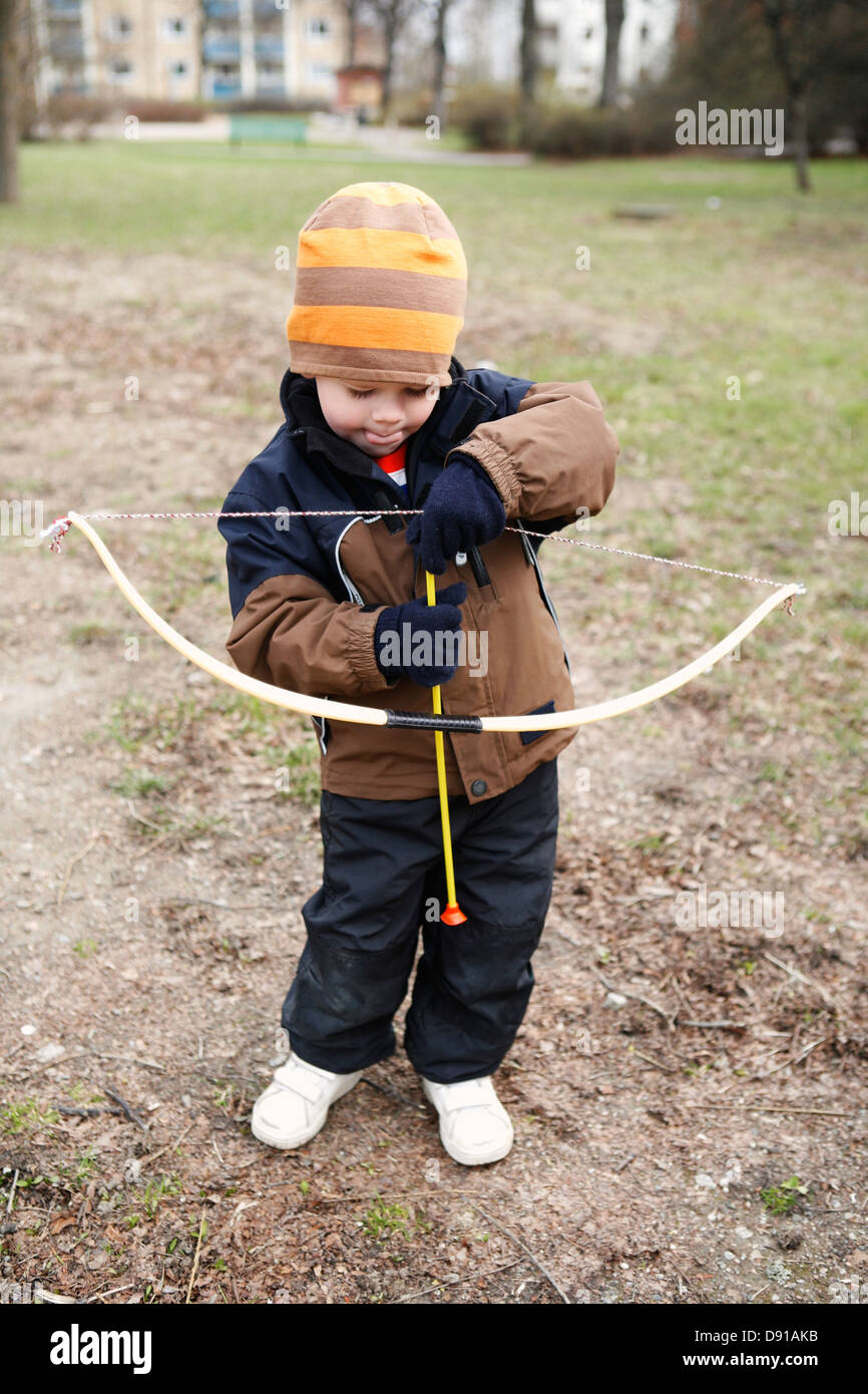 A boy playing with a bow, Sweden Stock Photo - Alamy