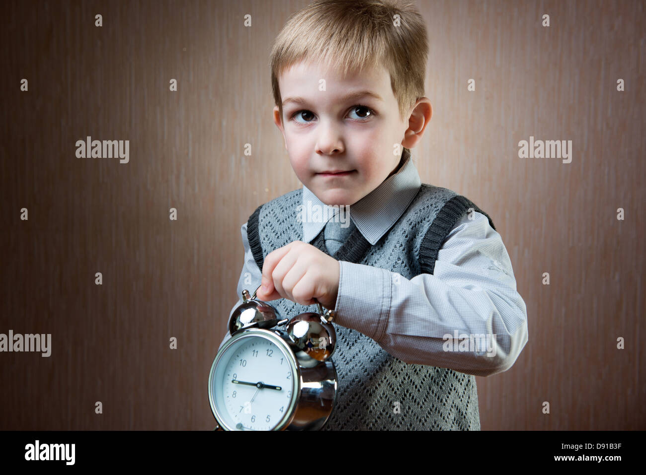 Cute little blond boy holding alarm clock Stock Photo - Alamy