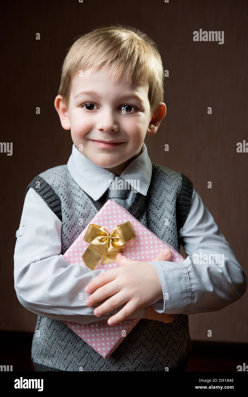 Cute little boy holding dotted present boy for Mother's Day Stock Photo ...