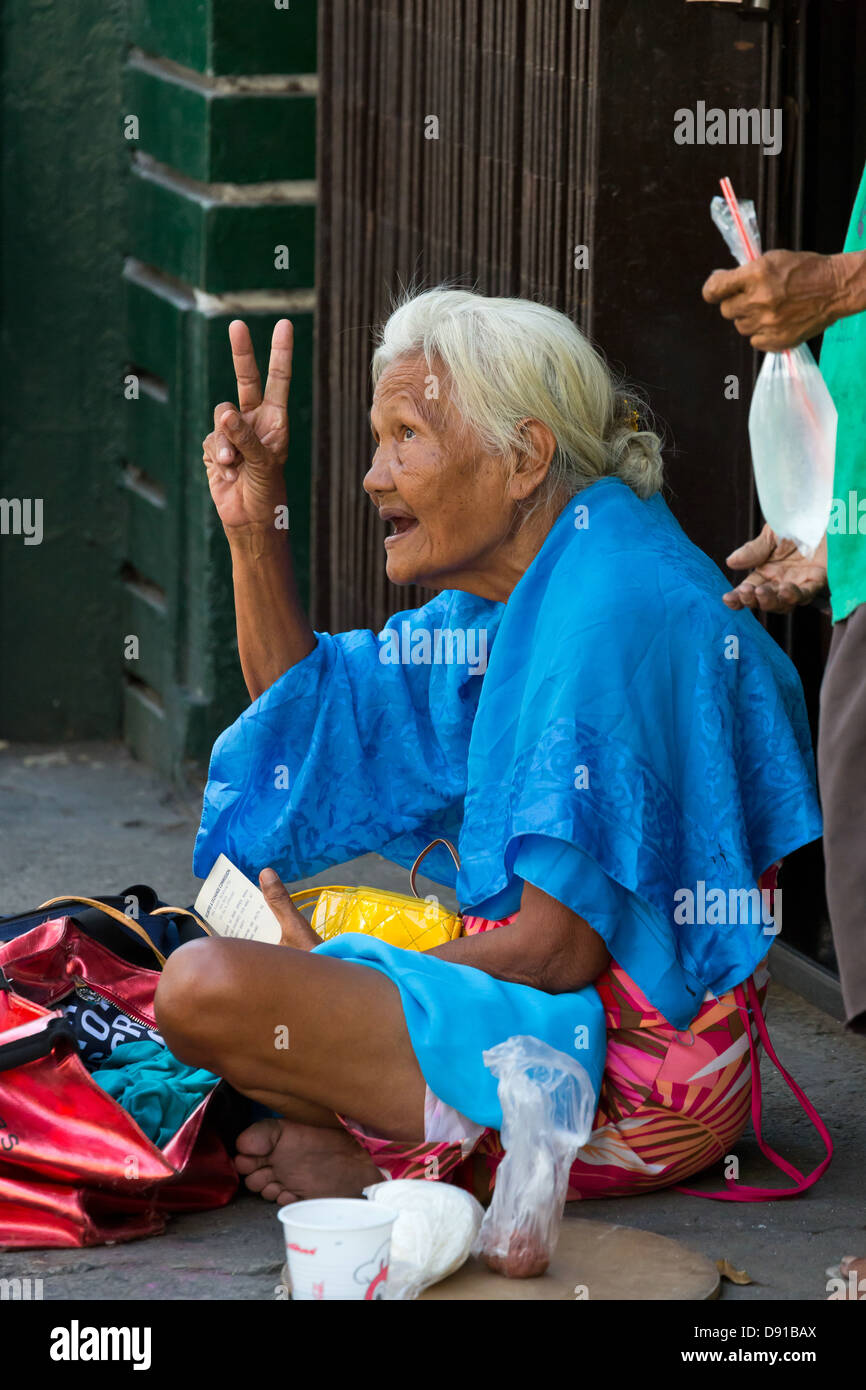 Old Woman in the Street in Manila, Philippines Stock Photo - Alamy
