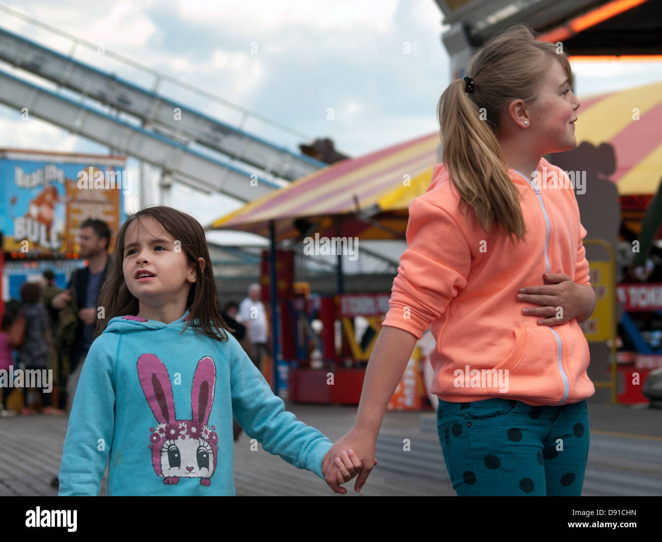Two girls holding hands hi-res stock photography and images - Alamy