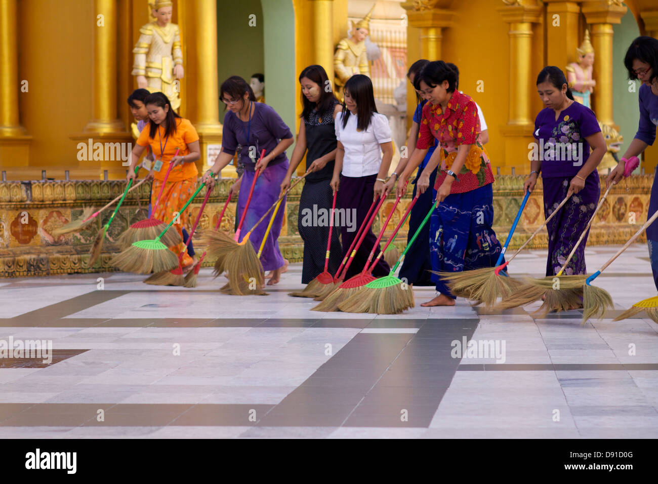 It is considered a good deed to help sweep the Shwedagon Pagoda marble ...