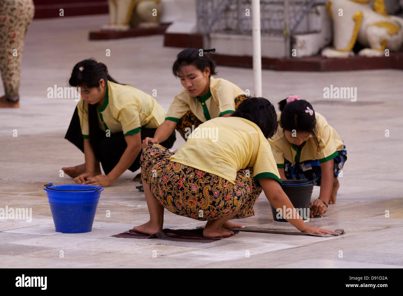Women cleaning the marble flooring within the Shwedagon Pagoda complex ...