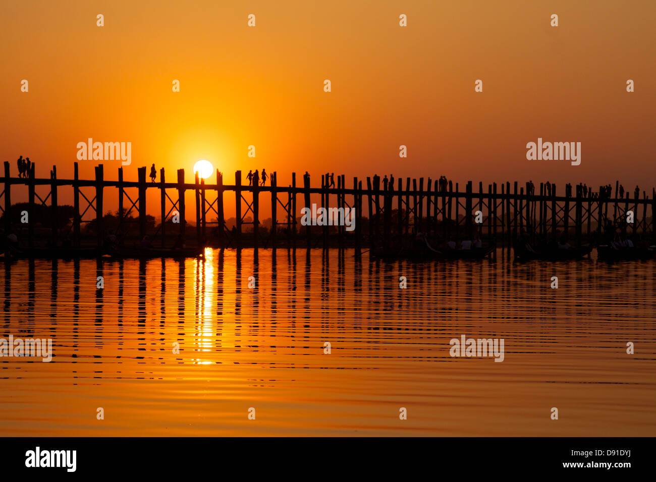 The sun sets behind the U Bein bridge the longest teak bridge in the ...