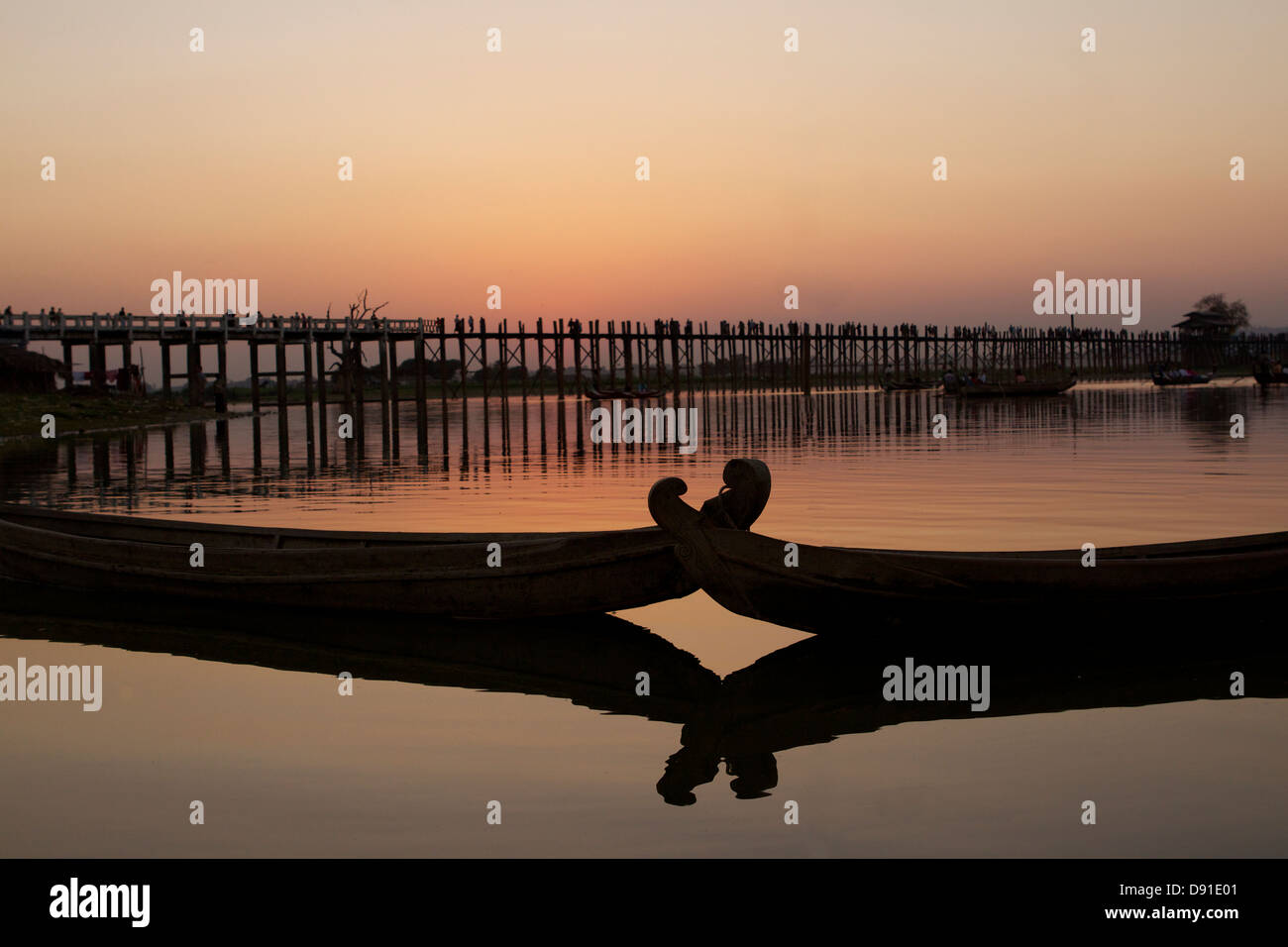 The sun sets behind the U Bein bridge the longest teak bridge in the ...