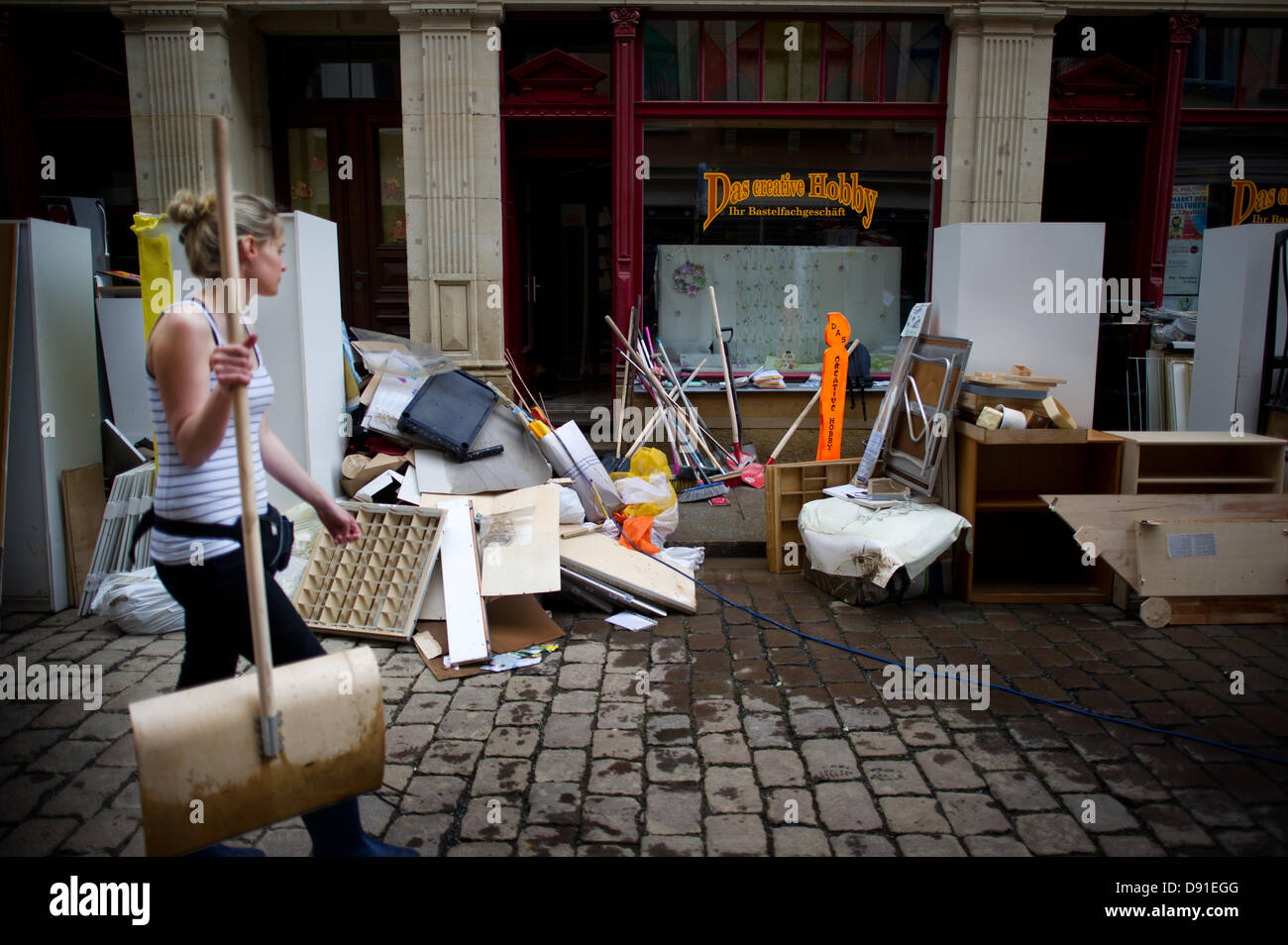 Items of a crafts store lie in front of the shop after it was flooded ...