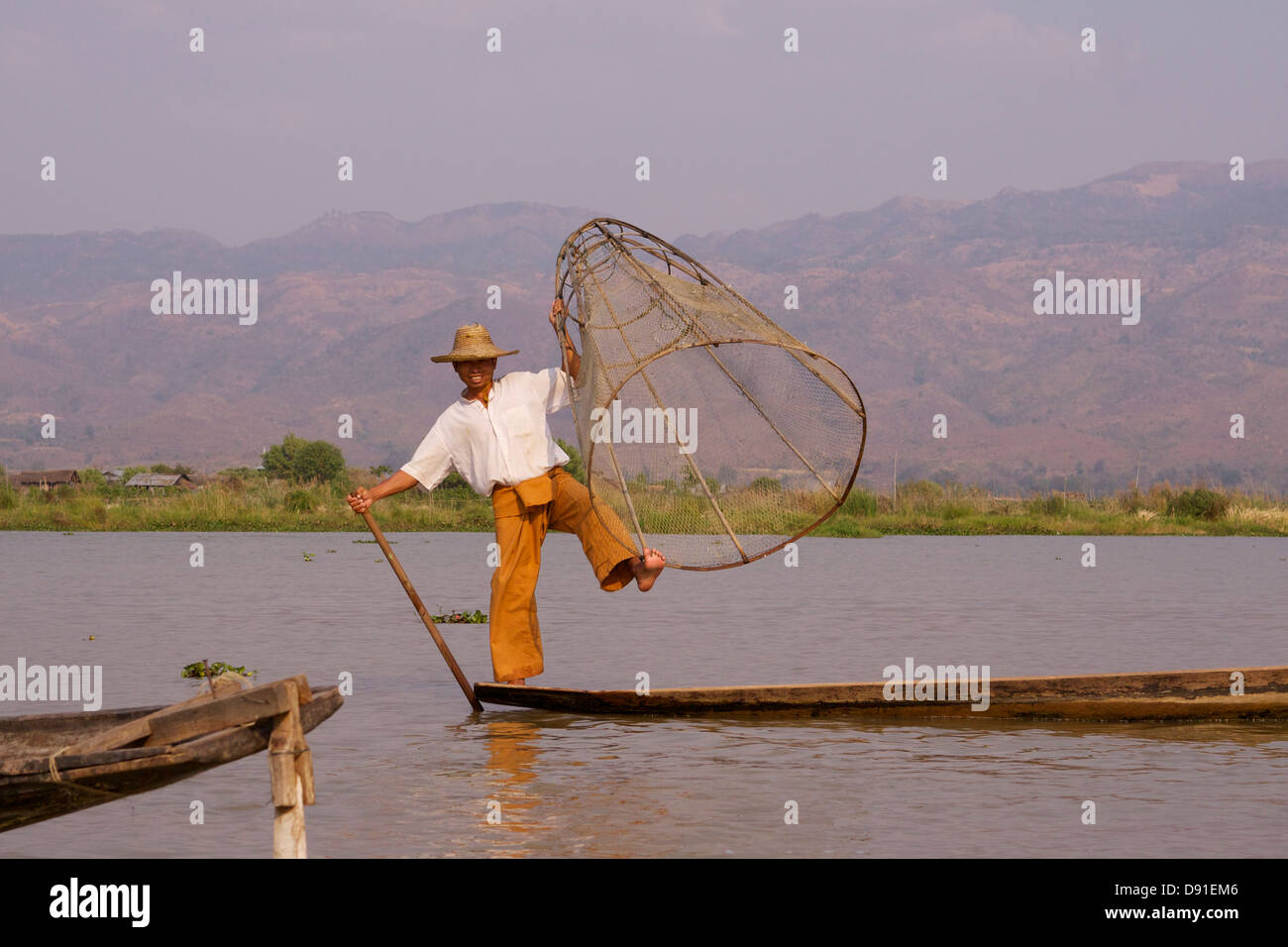 An traditional 'leg rower' fisherman on Inle Lake wearing the ...