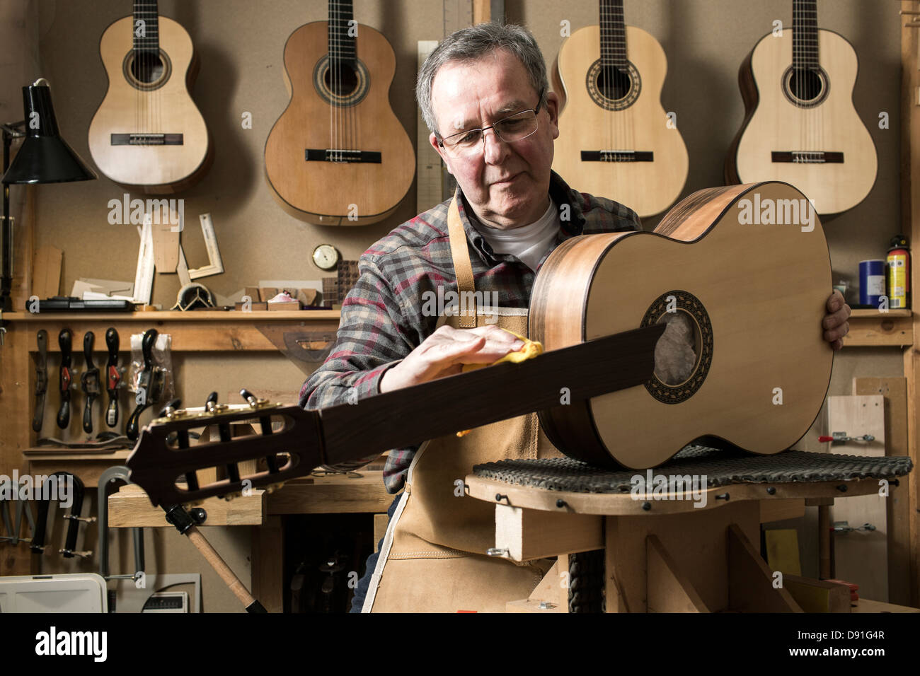 Guitar maker finishing acoustic guitar in workshop Stock Photo - Alamy
