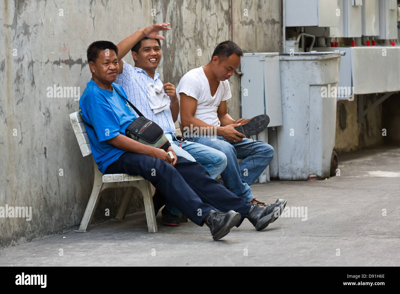 Three Men on a Bench in Manila, Philippines Stock Photo - Alamy