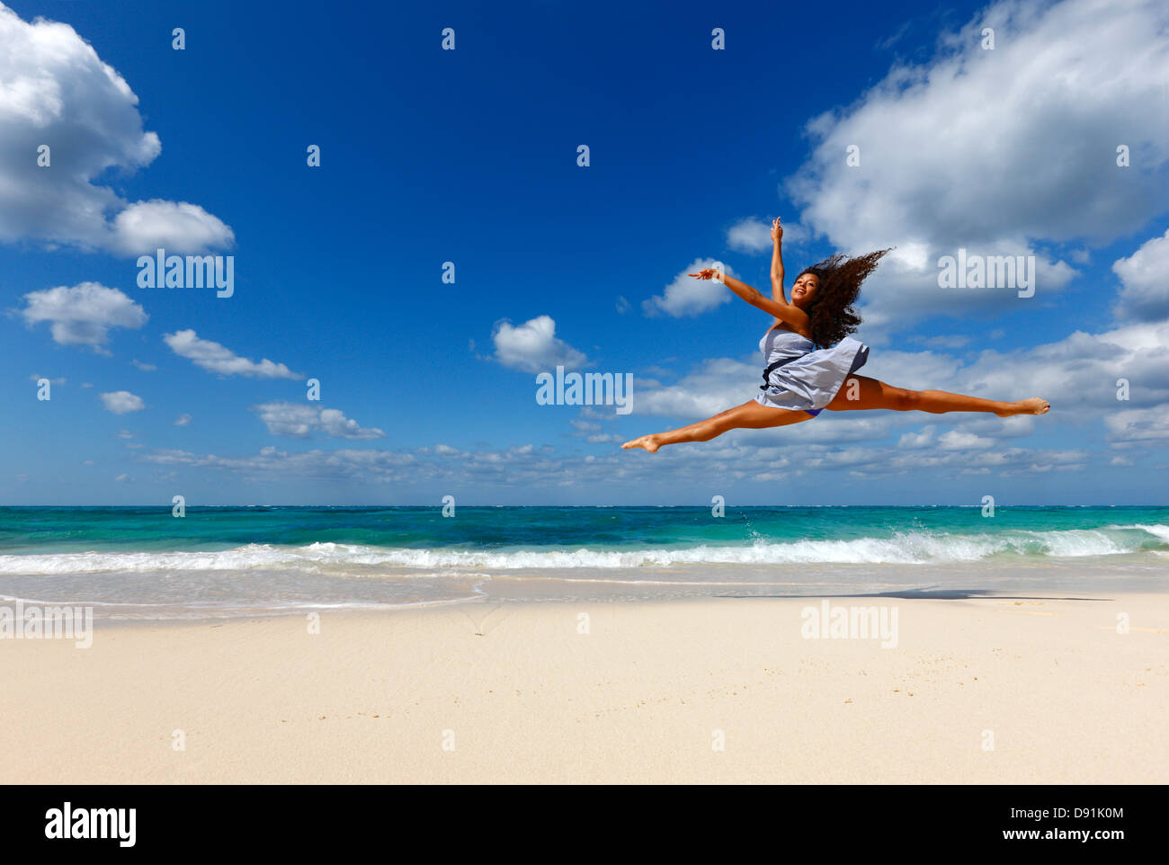 Female jump on the sand beach Stock Photo - Alamy