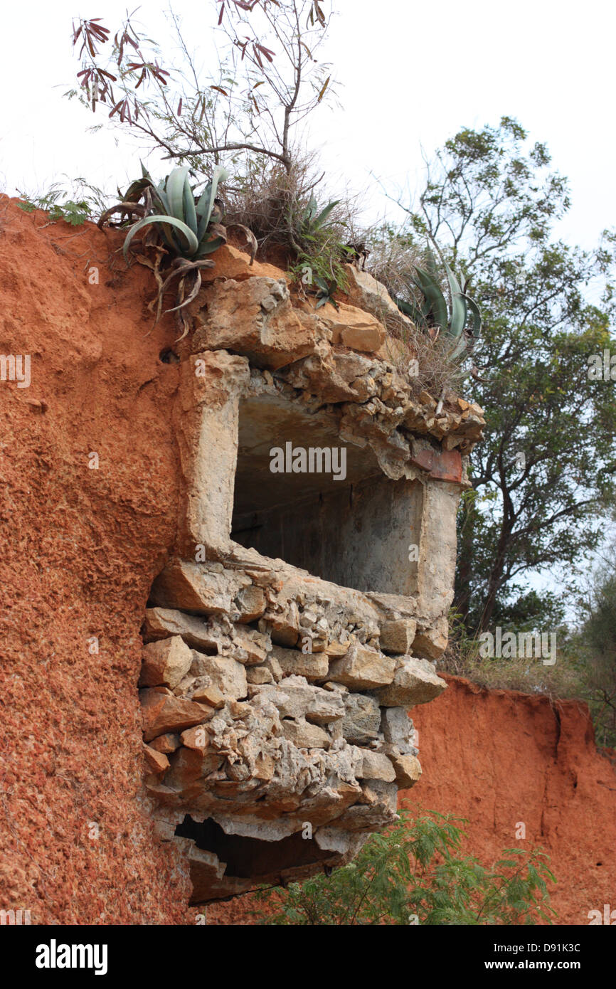 Old military bunker protrudes from a cliff on a beach. Jincheng, Kinmen ...