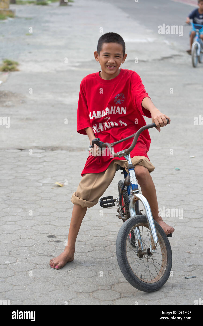 Little Boy on his Bike in Manila, Philippines Stock Photo - Alamy