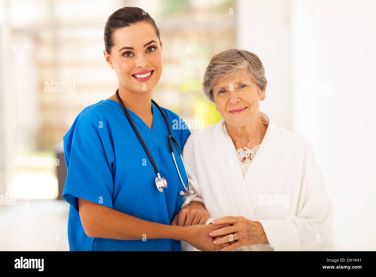 senior woman and caring young nurse Stock Photo - Alamy