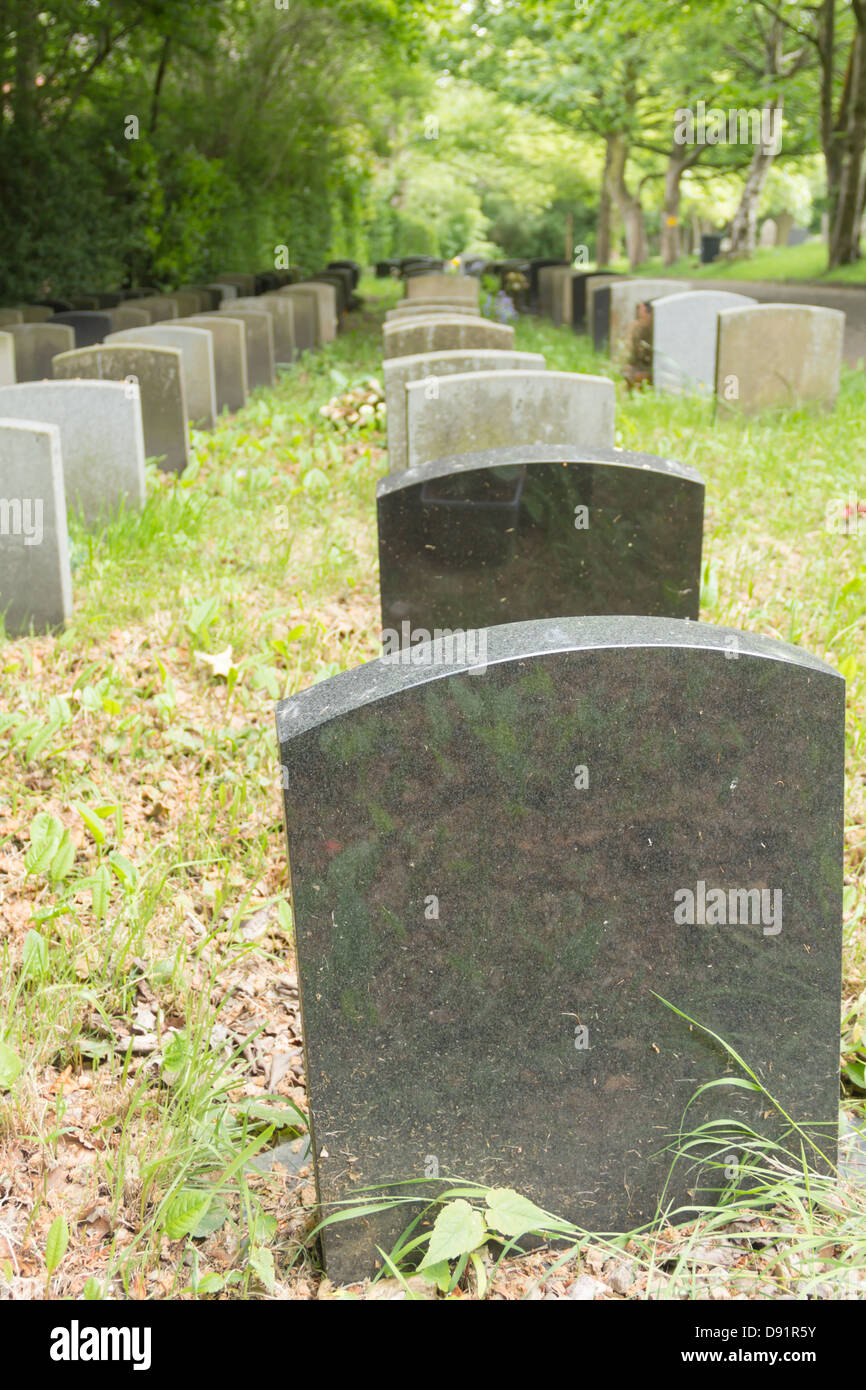 Rows of gravestones, viewed from the rear, in a church graveyard in ...