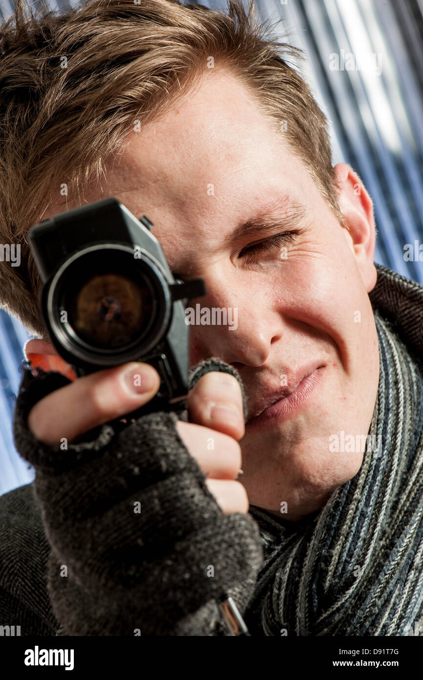 Young man with movie camera Stock Photo - Alamy