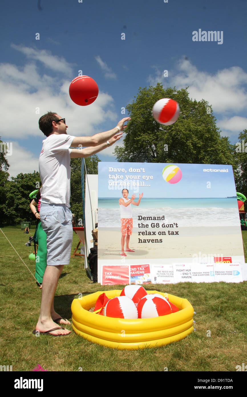 London 8 June 2013. A volunter poses for photos at the Action Aid stall ...