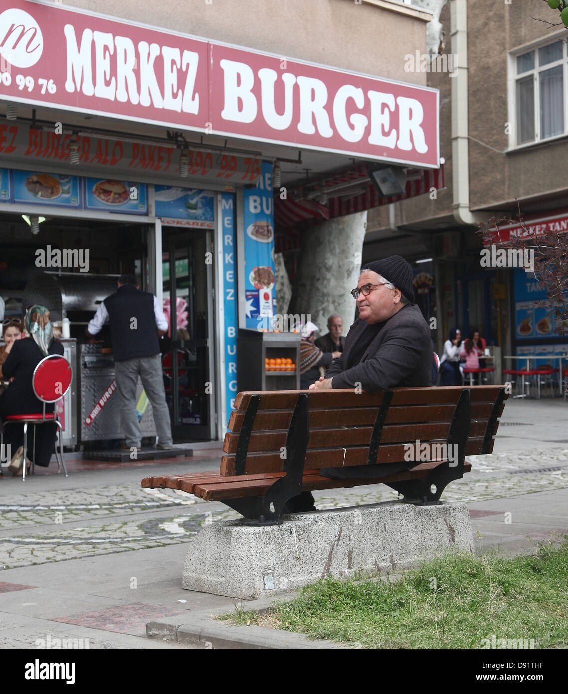 Older man relaxing on a bench in Pendic, Istanbul, Turkey, April 2013 ...