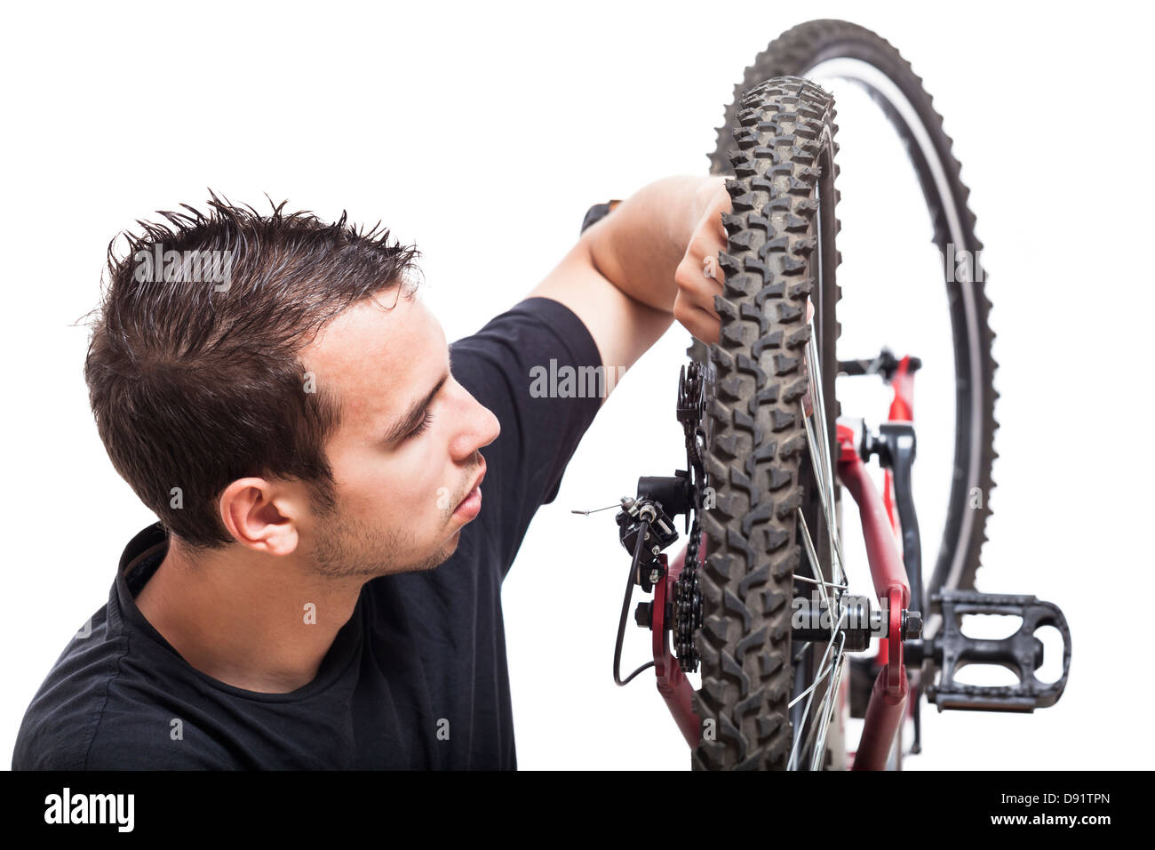 Young man checking his bicycle, isolated on white background Stock ...