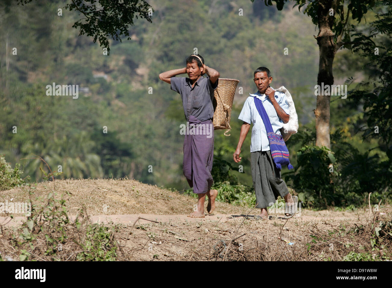 Tribal men walking in the countryside, Ruma Bazaar, Chittagong Hill ...
