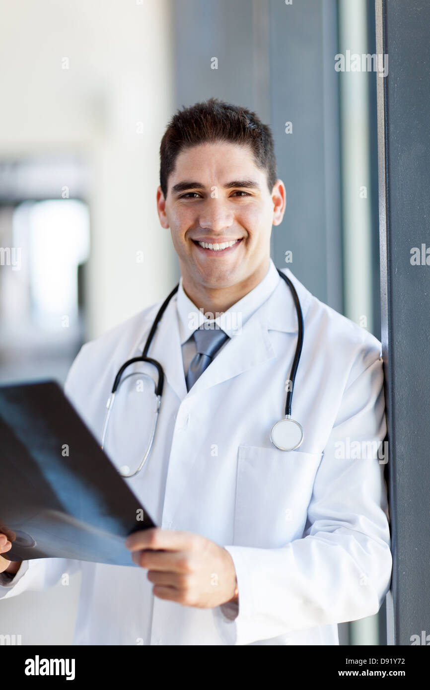 smiling young male doctor holding CT scan film in hospital Stock Photo ...