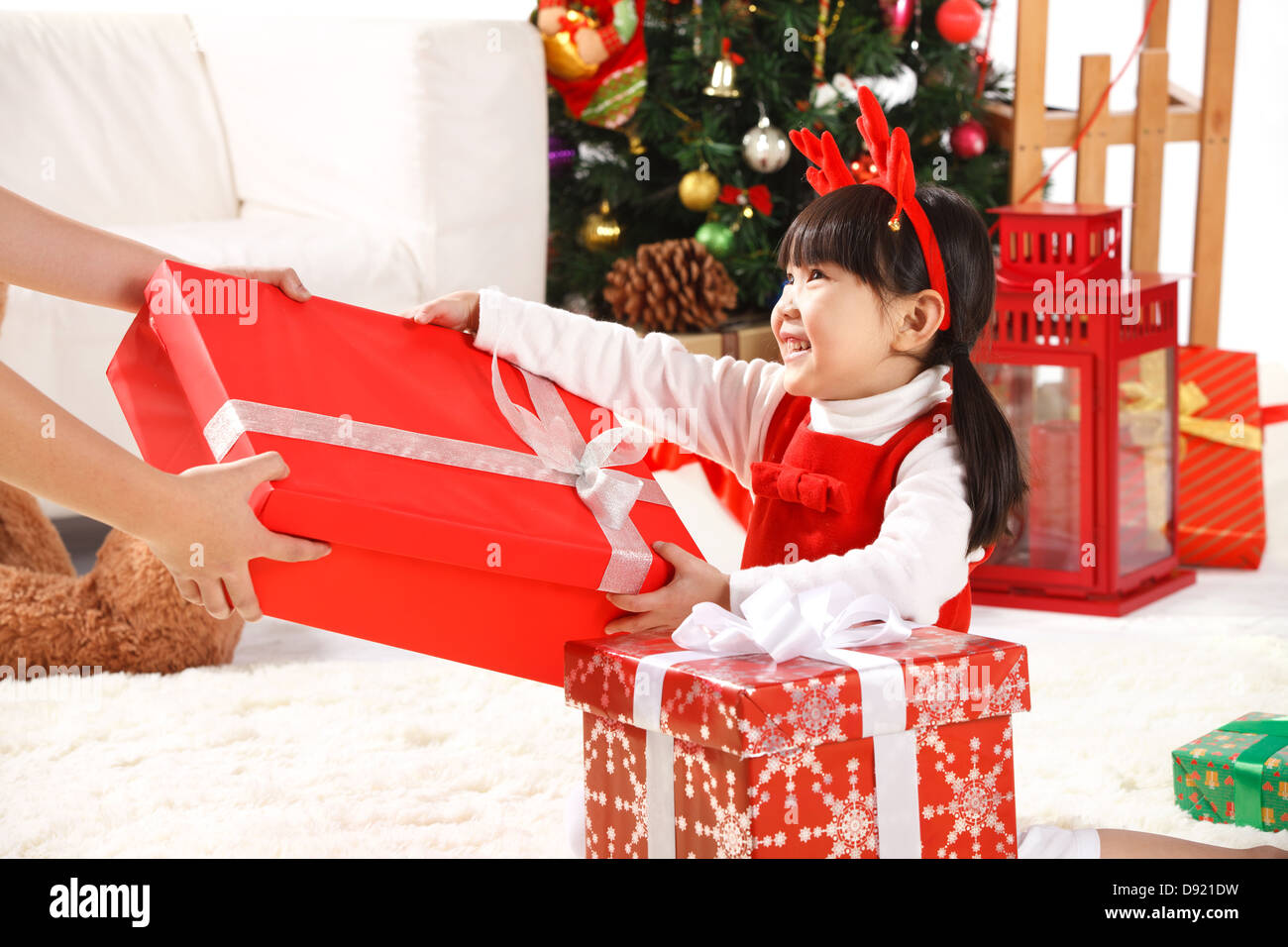 Girl receive Christmas gift Stock Photo - Alamy
