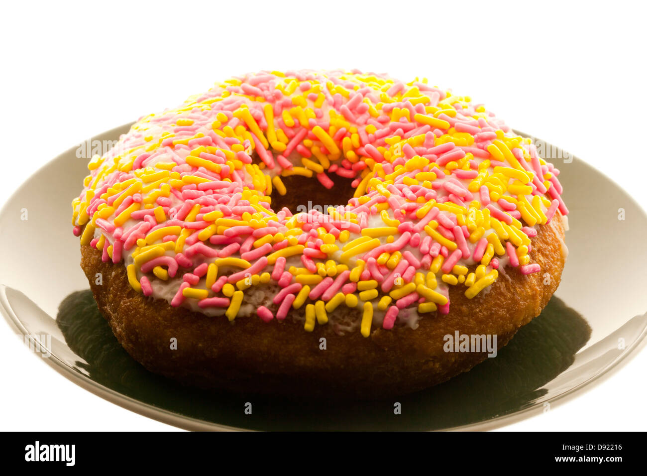 Sprinkle donut on plate Stock Photo - Alamy